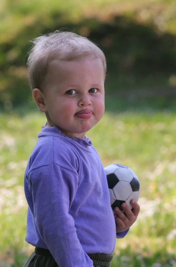 Boy falls playing football stock photo. Image of youngster - 3179994