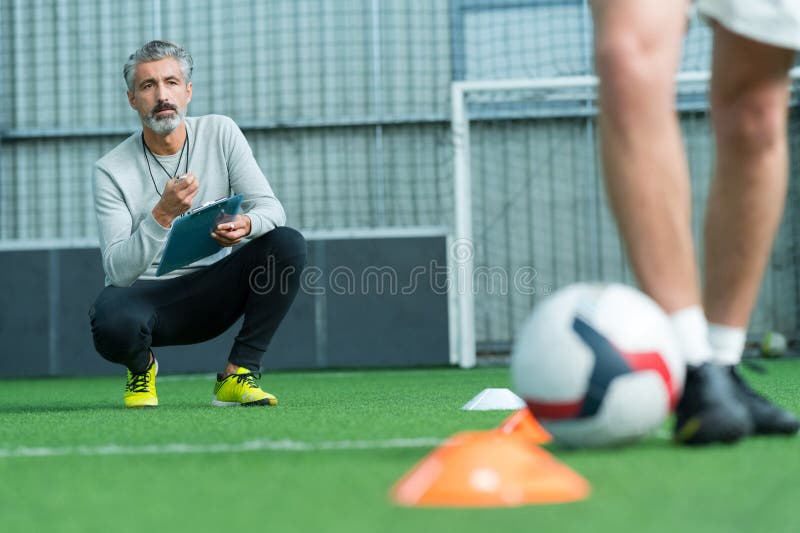 Football Coach Watching Young Man Training Stock Photo - Image of ...
