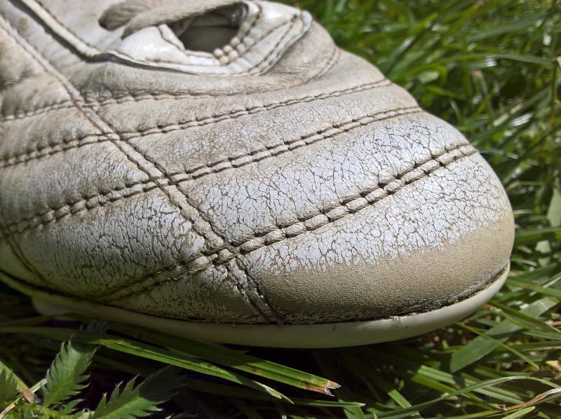 An Old Worn-out Football Sneaker With Multicolored Roofing Screws ...