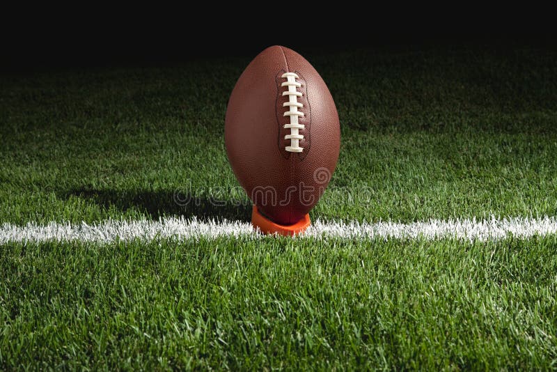 Football on Tee at Night Ready for Kickoff Stock Image - Image of ball ...