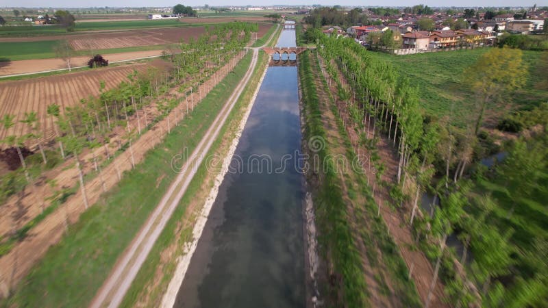Footbridge Across the River between Fields and Tree Planting in the ...