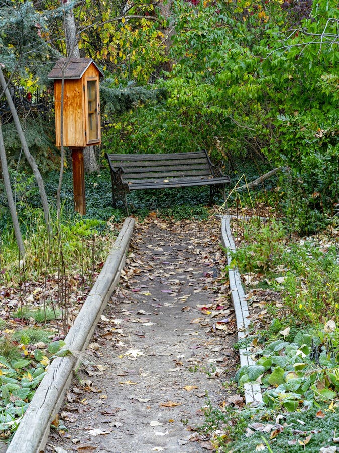 Footpath Leads To a Park Bench in a Public Garden Stock Photo - Image ...