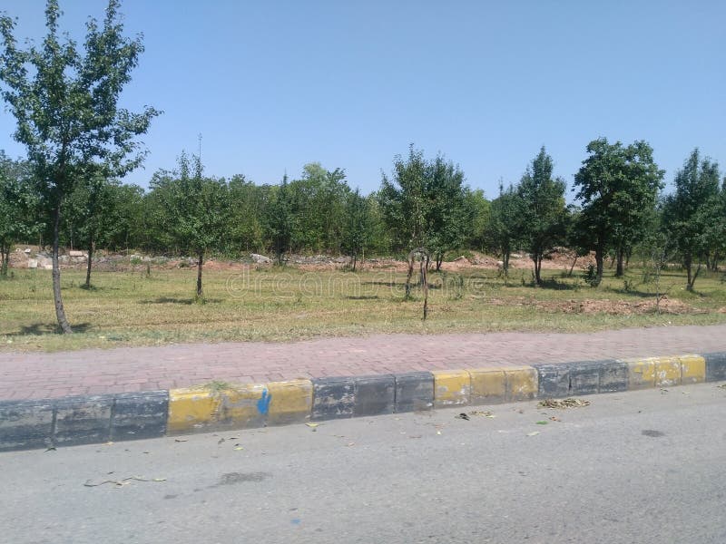 Footpath view in Islamabad stock photo. Image of lawn - 220352884