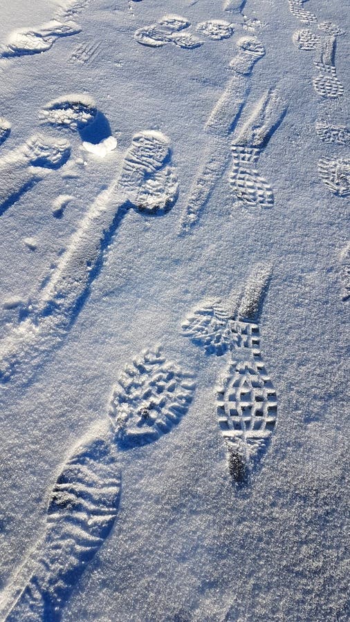 Footprints on a Frozen Lake in the Mountains during a Hike. Stock Photo ...