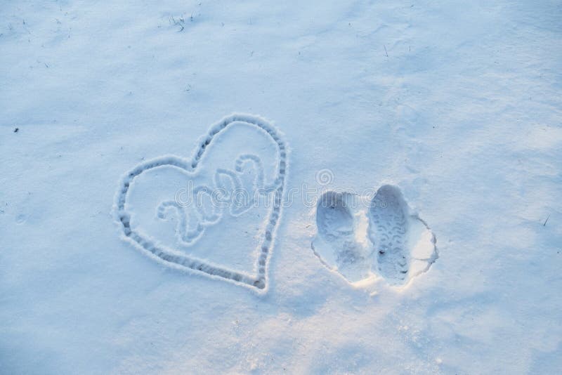 Footprints a Heart and 2022 To Step into New Year Painted in the Snow ...