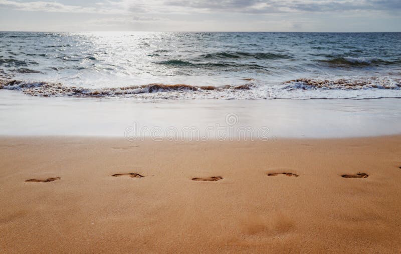 Footprints in the Sand at Sunset. Sandy Tropical Beach with Sea Waves ...