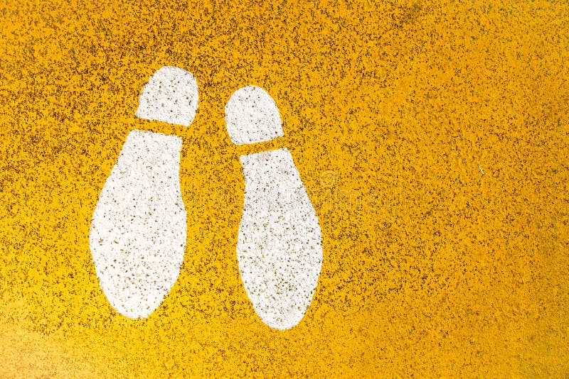 Yellow Footprint Signs on an Asphalt Road. Painted Footprints Show the ...