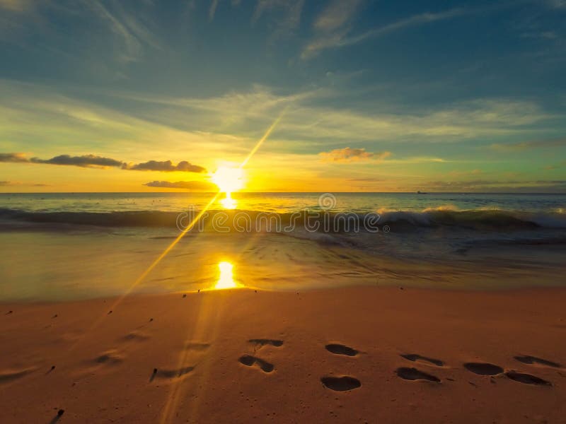 Footsteps on the Beach with a Warm Sunset Stock Photo - Image of autumn ...