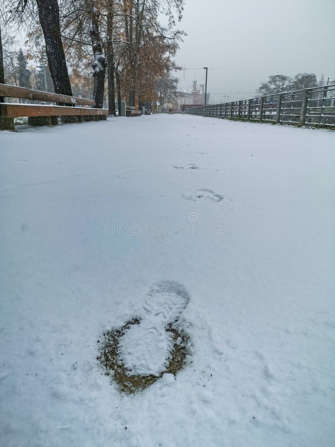 Footsteps Imprinted on the Snow at Pathway Next To River Stock Photo ...