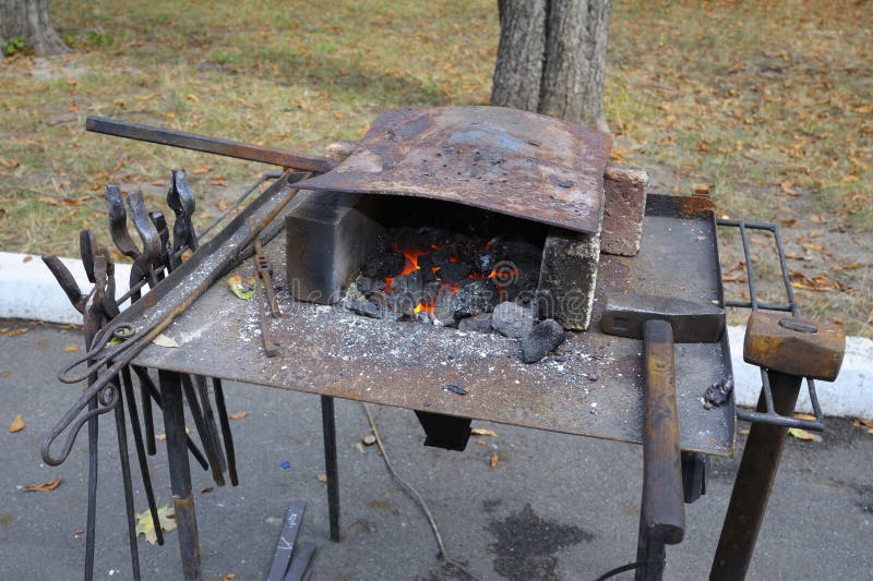 Forceps, Hammer and Burning Forge Ready for Work. at the Smithy ...