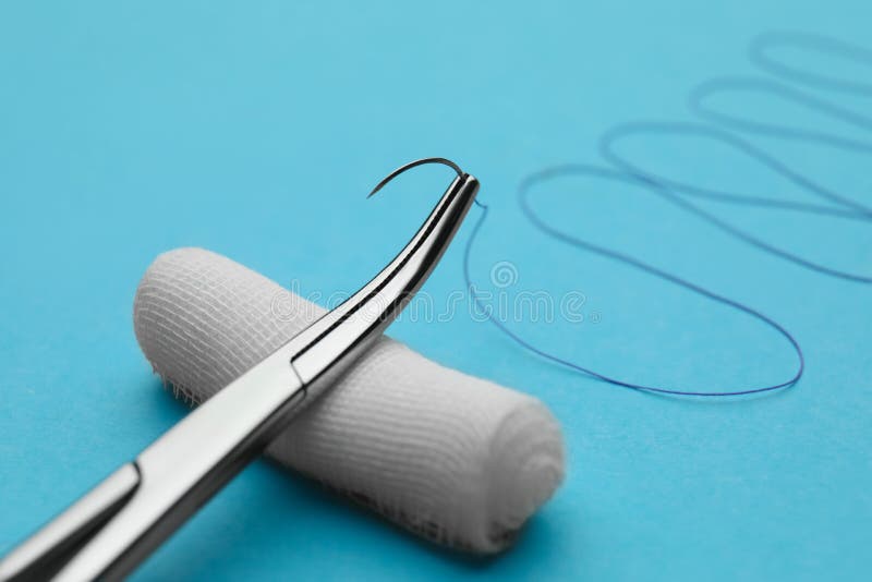 Forceps with Suture Thread and Bandage Roll on Light Blue Background ...