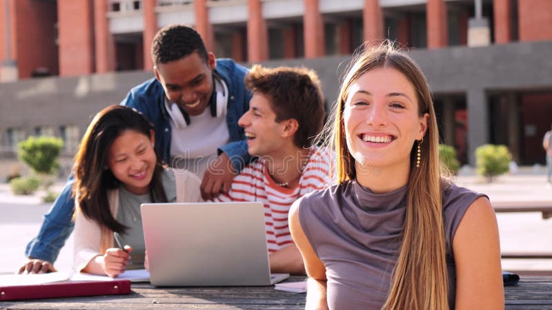 At Foreground a Confident Female Student Looking at Camera while ...