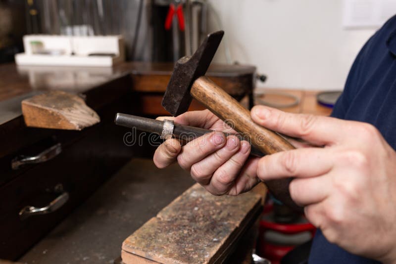 Foreground, Hammer Hammering a Silver Ring To Shape it in a Jewelry ...