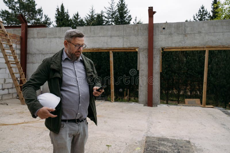 Foreman or Architect on Construction Site with Mobile Phone Stock Photo ...