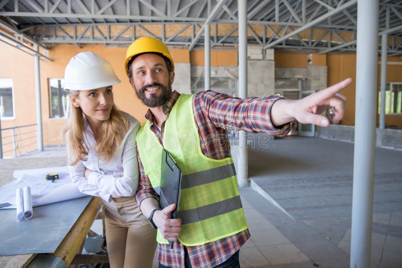 Foreman in Builder Uniform Talking with Contractor on Construction Site ...