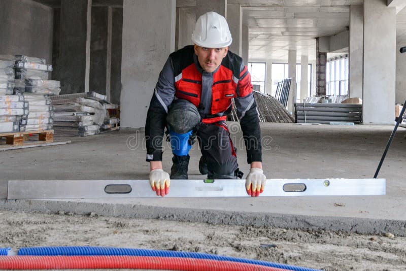 A Foreman at a Construction Site in Work Clothes Controls the Work ...