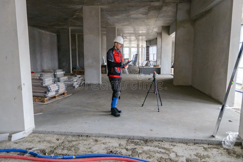 A Foreman at a Construction Site in Work Clothes Controls the Work ...