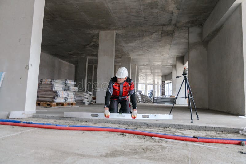 A Foreman at a Construction Site in Work Clothes Controls the Work ...
