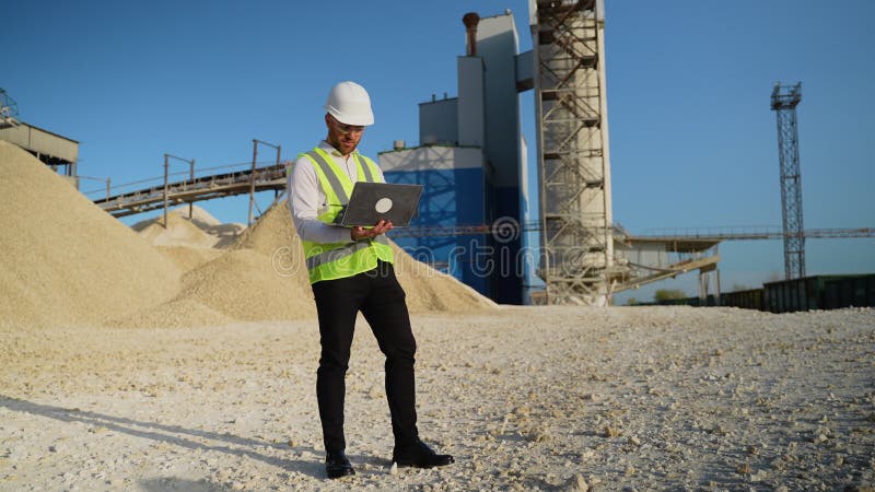 Foreman Engineer with Laptop Instructing Workers Using Walkie Talkie ...
