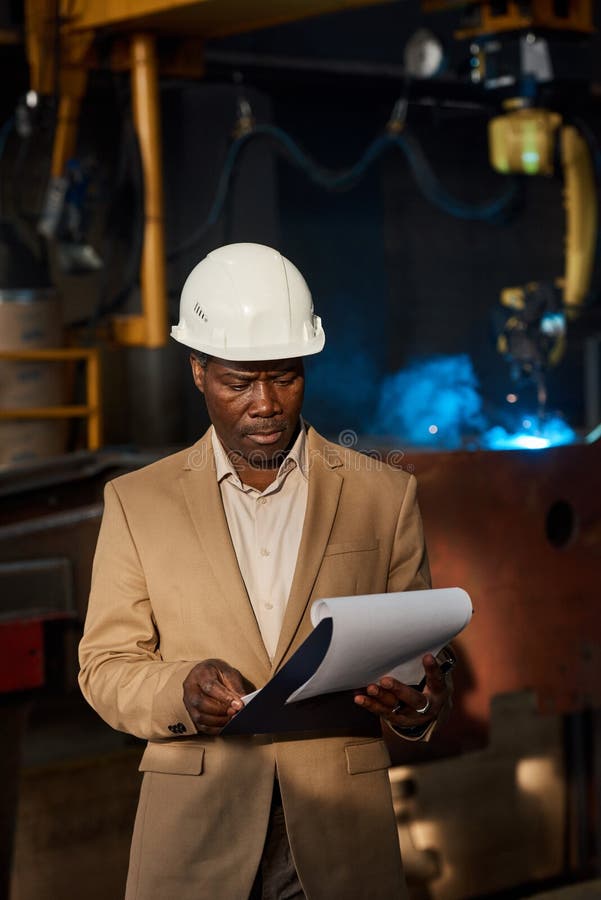 Foreman Examining Manufacturing Plan in Plant Stock Image - Image of ...