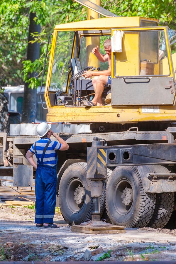 The Foreman Gives Instructions To the Working Crane Operator on the ...