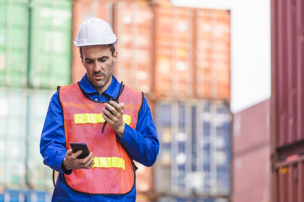 Foreman in Hardhat and in Safety Gear Talks on Two-way Radio Control ...