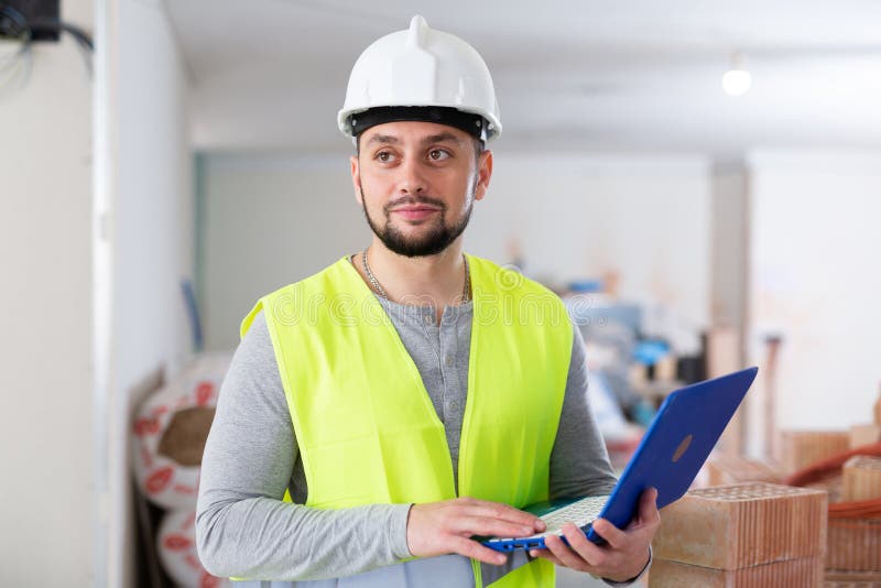 Foreman with Laptop on Indoor Construction Site Stock Image - Image of ...