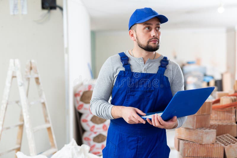 Foreman with Laptop on Indoor Construction Site Stock Image - Image of ...