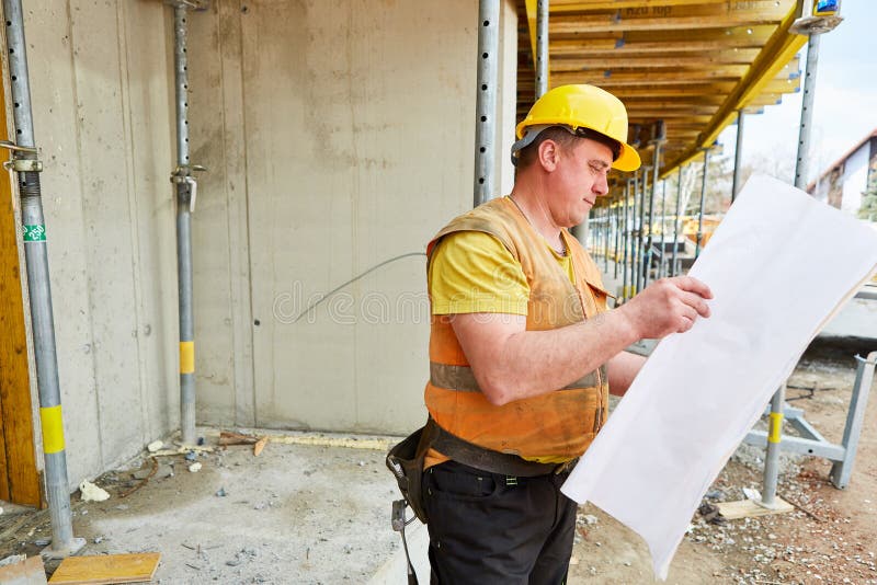 Foreman Looks at Construction Drawing on the Construction Site Stock ...