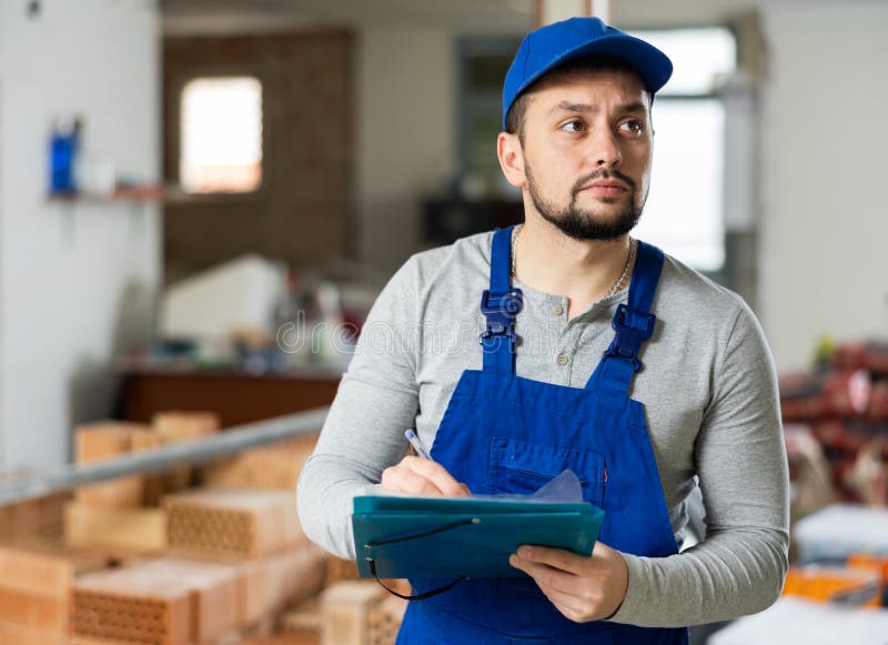 Foreman Making Task List during Works in Building Under Construction ...
