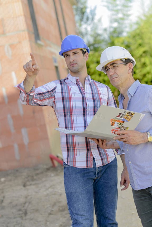 Foreman pointing at wall stock photo. Image of show - 336981478