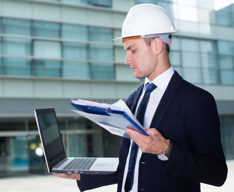 Foreman in Suit and Hat is Exploring Documents with Project and ...