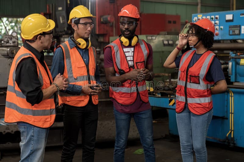 Foreman is Taking Orders in the Factory. Factory Worker and Engineer As ...