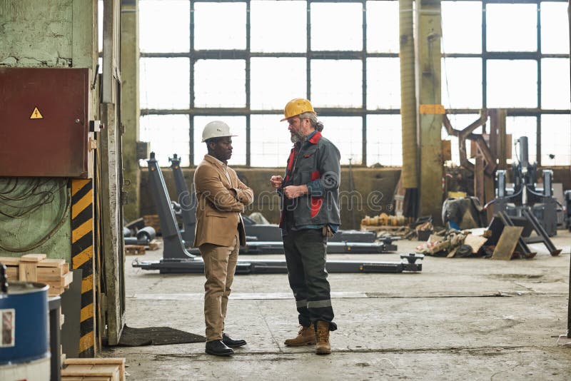 Foreman Talking To Worker in Factory Stock Image - Image of teamwork ...