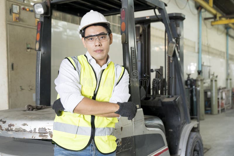 Foreman or Technician Standing with a Forklift Parked in the Factory ...