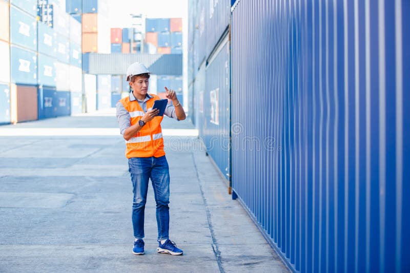 Foreman in Uniform Wearing Safety Helmet Using Tablet Checking ...