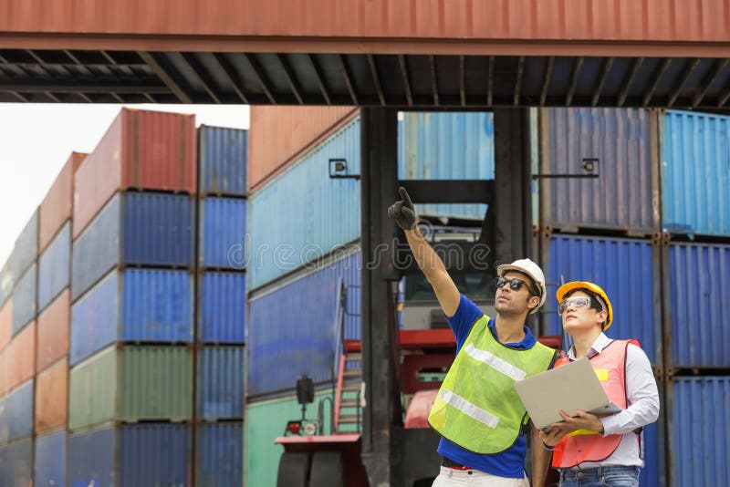 Foreman Using Laptop Computer in the Port of Loading Goods. Foreman ...
