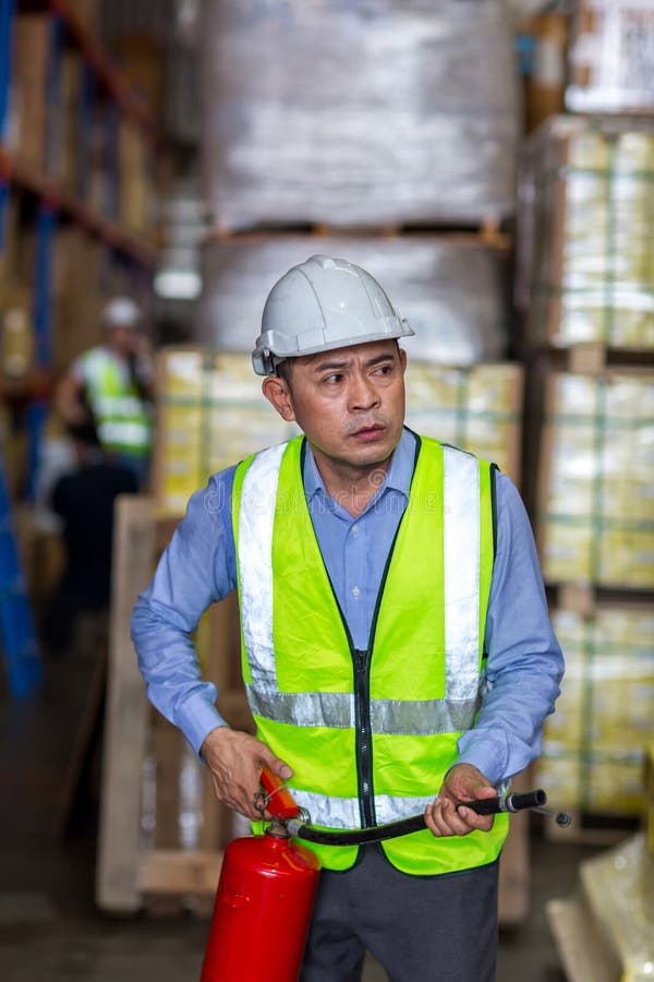 Foreman or Worker Holding a Fire Extinguisher and Ready Stop Fire in ...