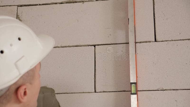Foreman Worker Using a Spirit Level and Marking the Concrete Wall with ...