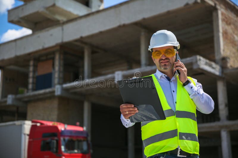 Foreman in Working Uniform Expertising the Structure Standing with ...