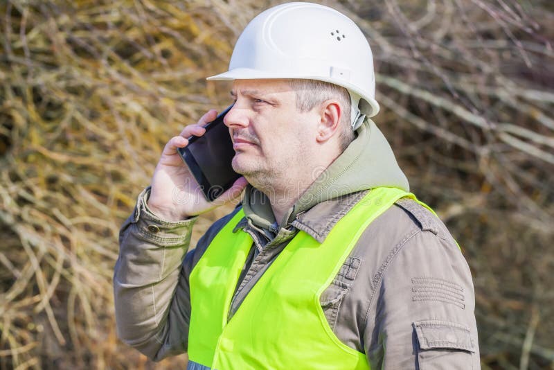 Forest Engineer Talking on Cell Phone Near Pile of Twigs Stock Image ...
