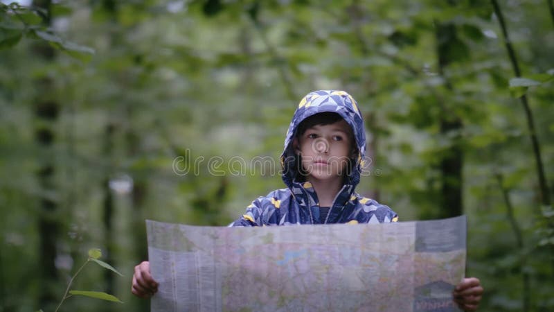 Forest Exploration: Boy Studying Map To Navigate Safely Stock Footage ...