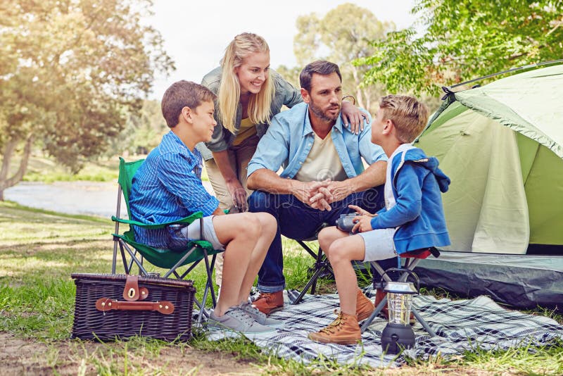 In the Forest with Family. a Family of Four Camping in the Woods. Stock ...