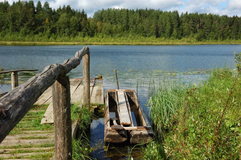 Forest Lake With Fishing Boat At Berth Picture. Image: 3925509