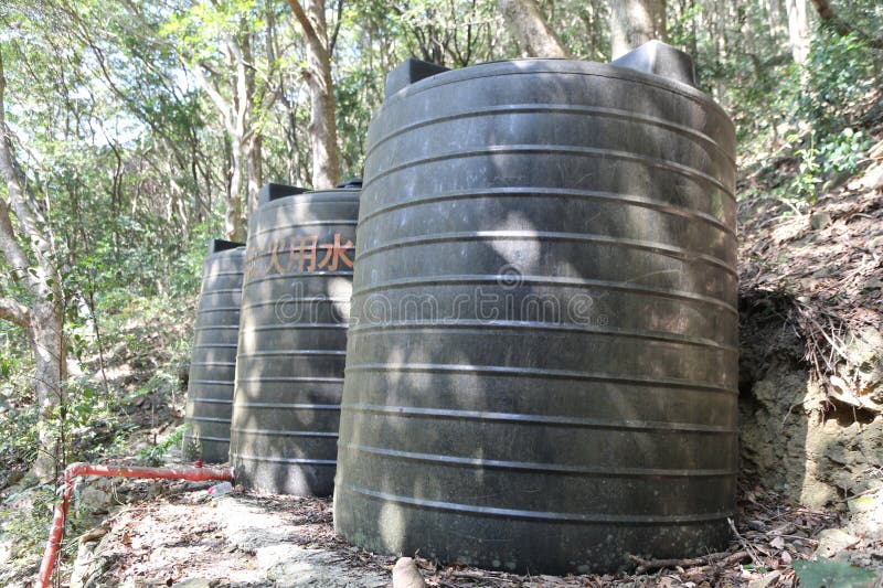 There is an Area of Black Plastic Water Tanks with Mildly High and ...