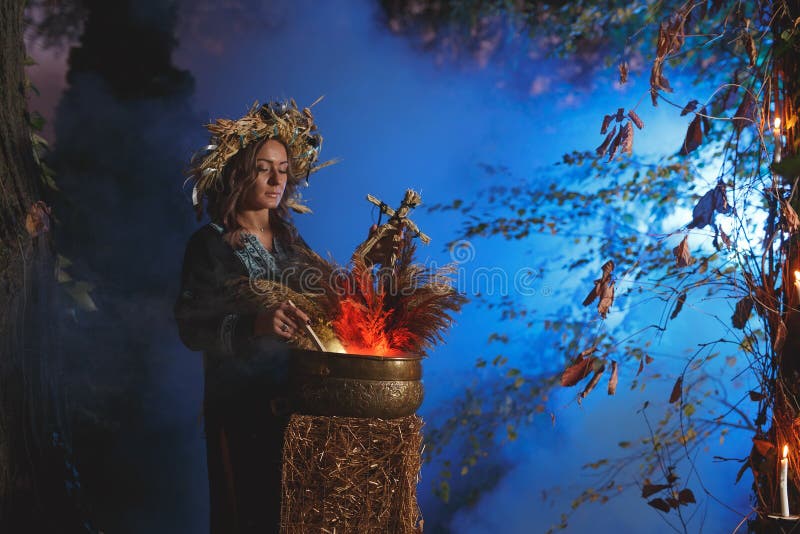 A Forest Witch Brews a Potion Holding a Voodoo Doll. Stock Image ...