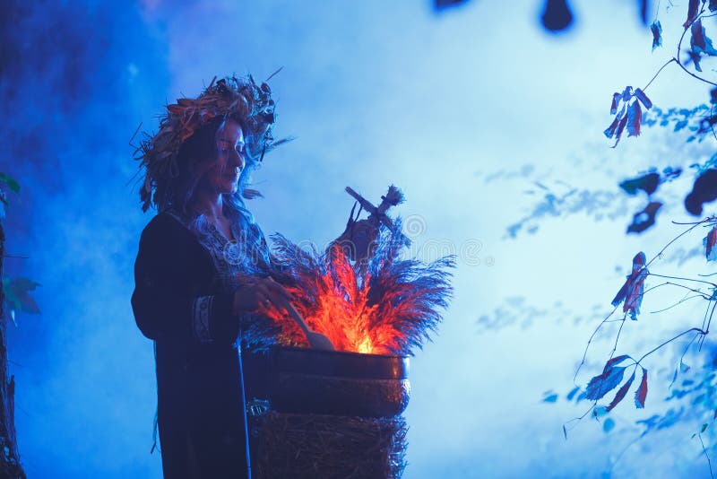 A Forest Witch Brews a Potion Holding a Voodoo Doll. Stock Photo ...