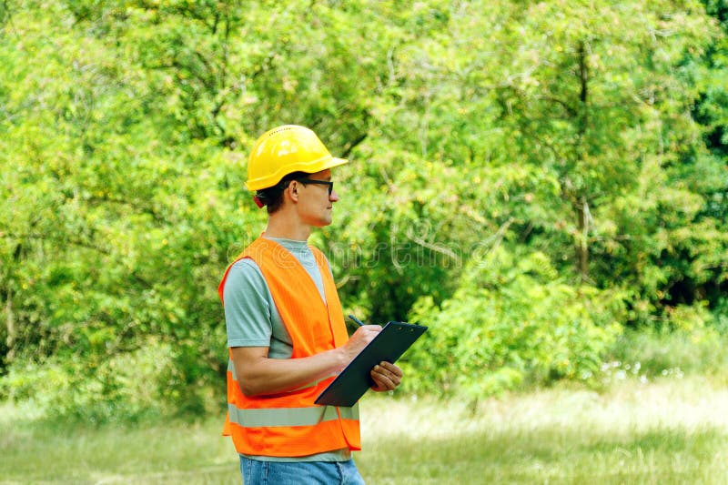 Forester Worker. Environmental Engineer Man in the Forest Notes the ...