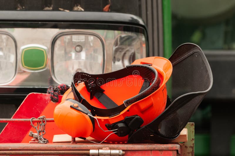 Forestry Protective Helmet with Earmuffs Lying on Tractor Stock Photo ...
