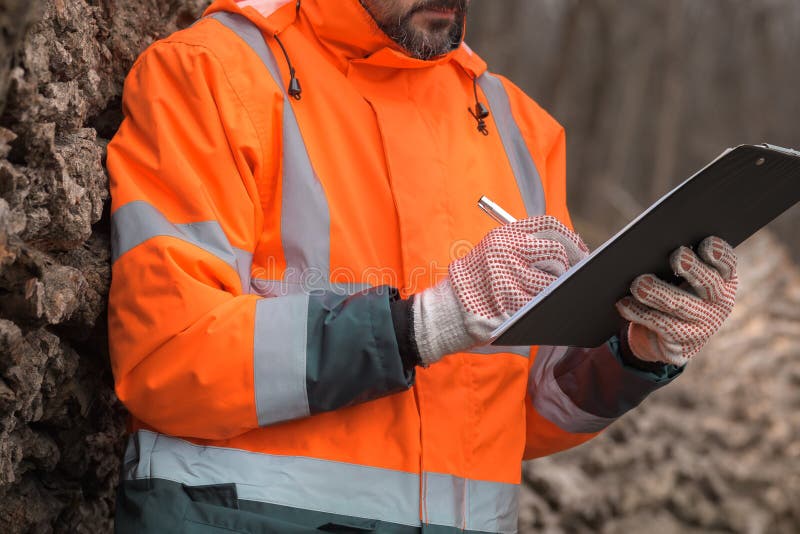 Forestry Technician Writing Notes on Clipboard Notepad Paper in Forest ...
